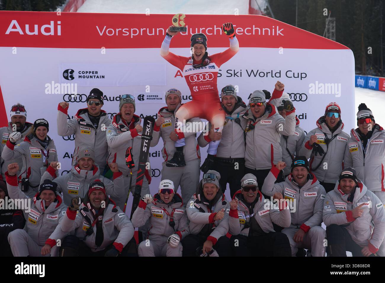 First place finisher Switzerland's Marco Odermatt poses with his team ...