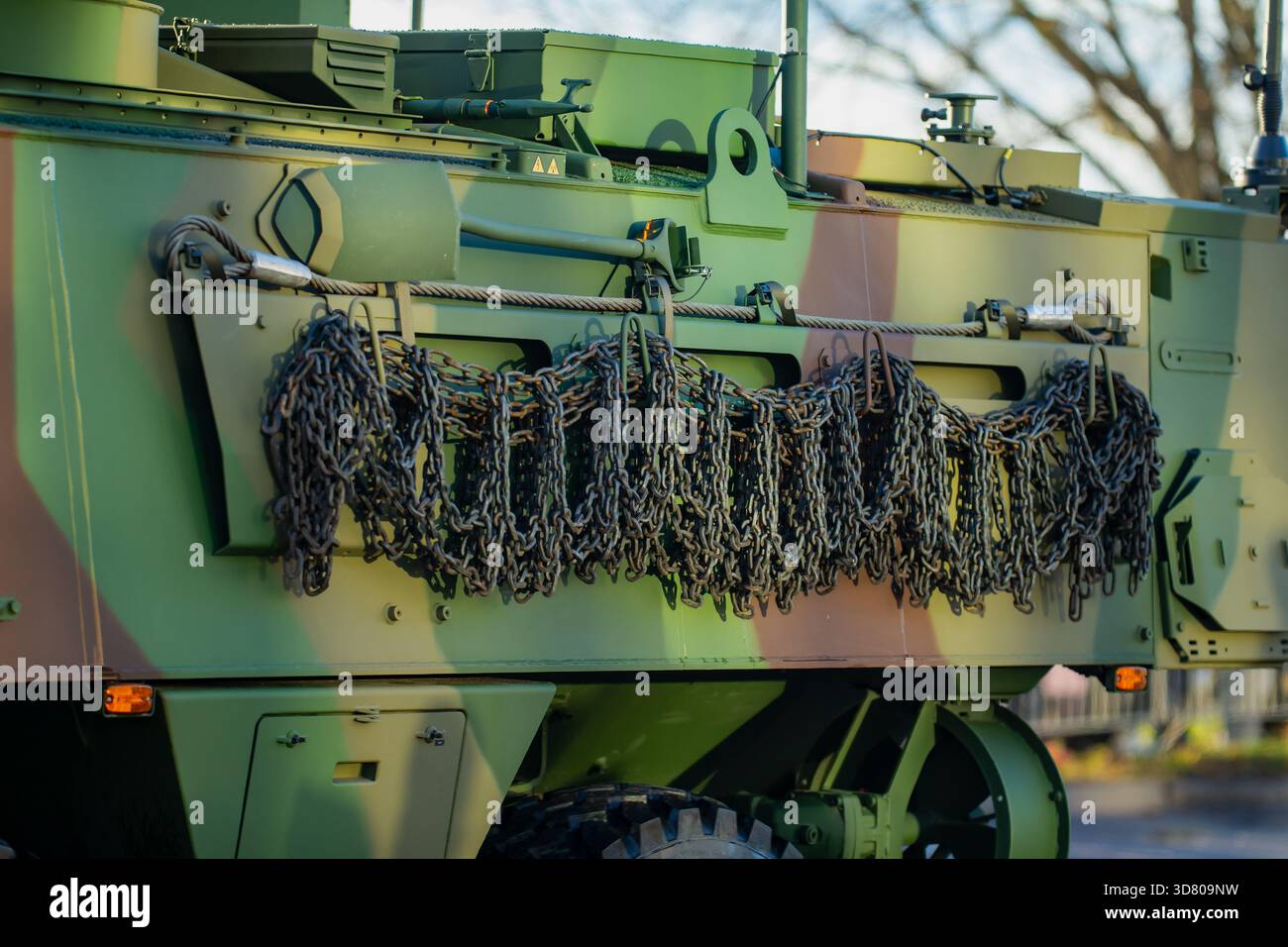Camouflaged NATO allied armored carrier showing heavy side mounted ...