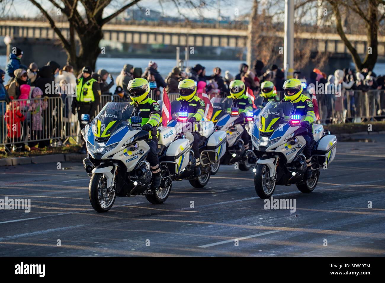 Motorcycle officers in reflective uniforms leading a law enforcement ...