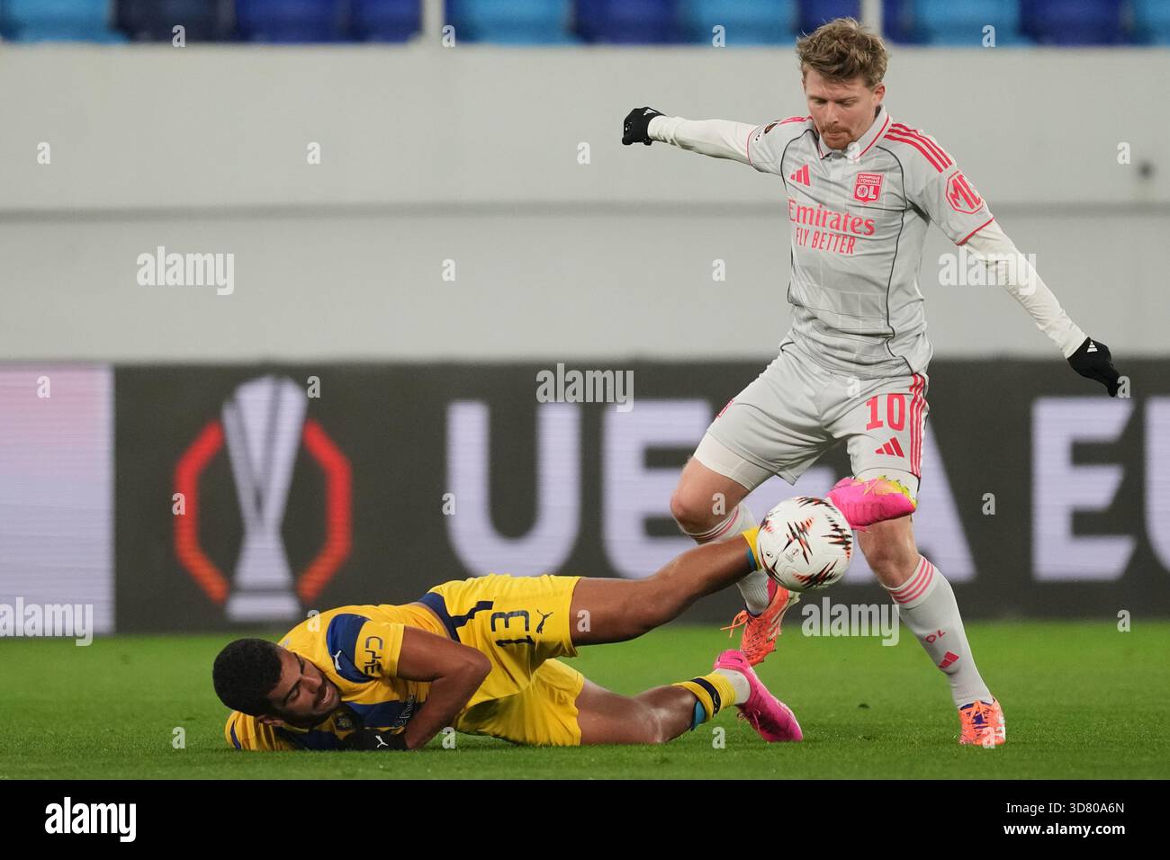 Maccabi Tel Aviv's Raz Shlomo, left, duels for the ball with Lyon's ...
