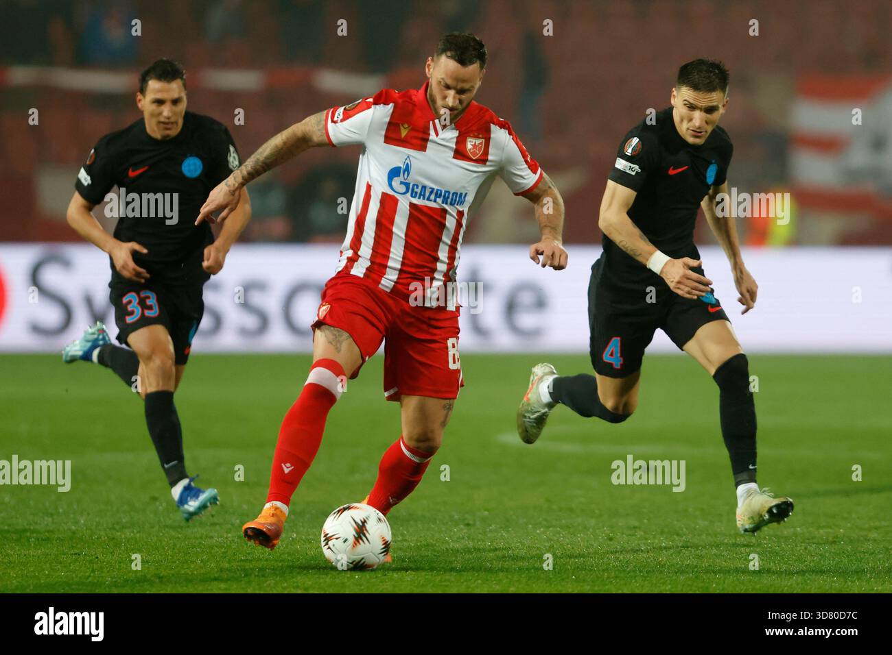 Red Star's Marko Arnautovic, center, runs with the ball past FCSB's ...