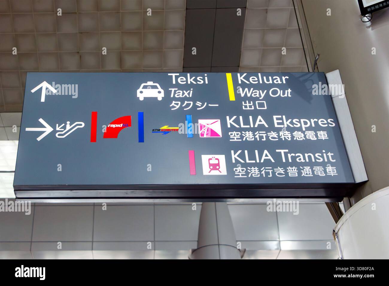 Airport directional sign in multiple languages for taxis, trains, and ...