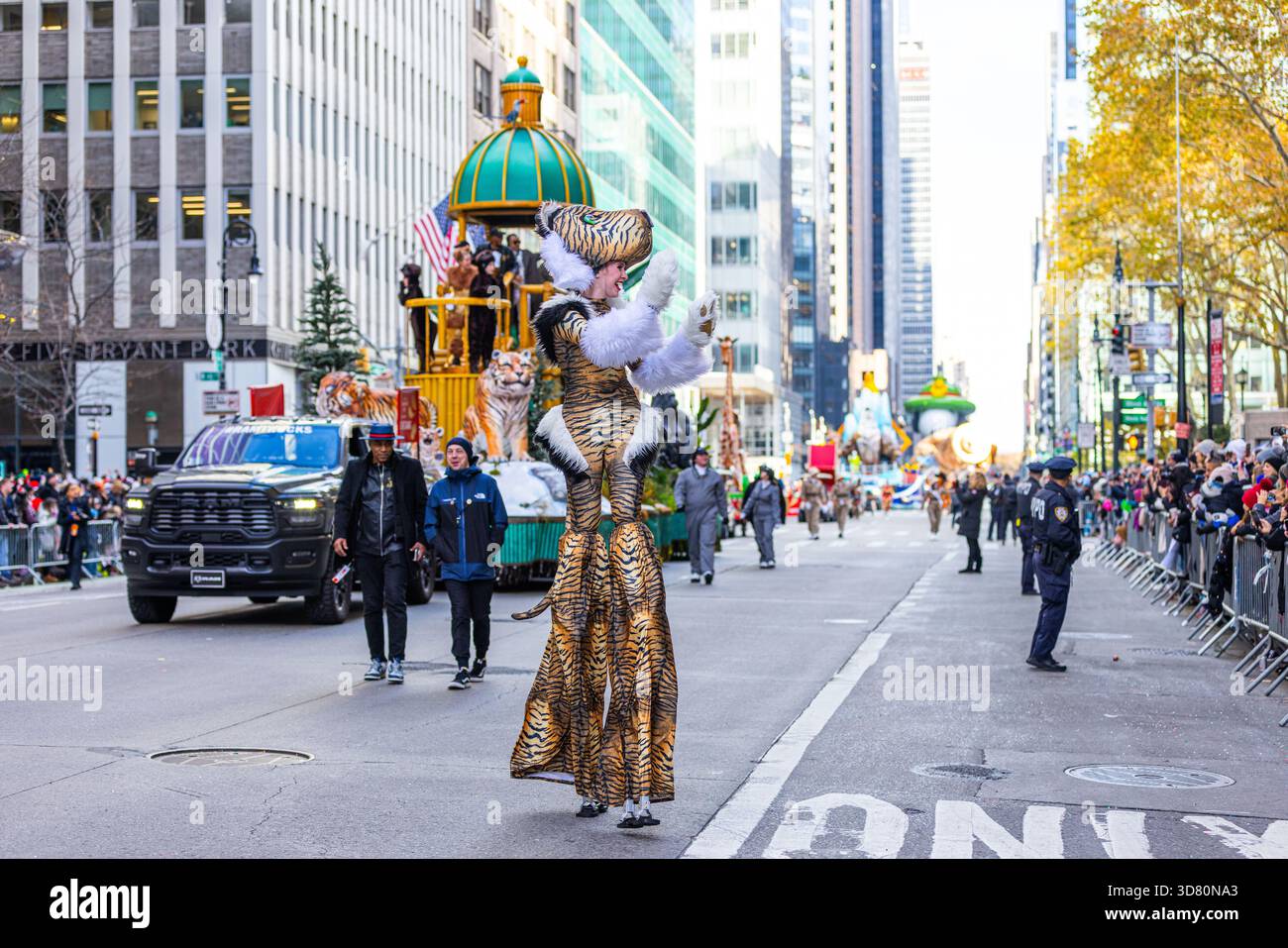 A performer in the 99th Annual Macy's Thanksgiving Day Parade wave to ...