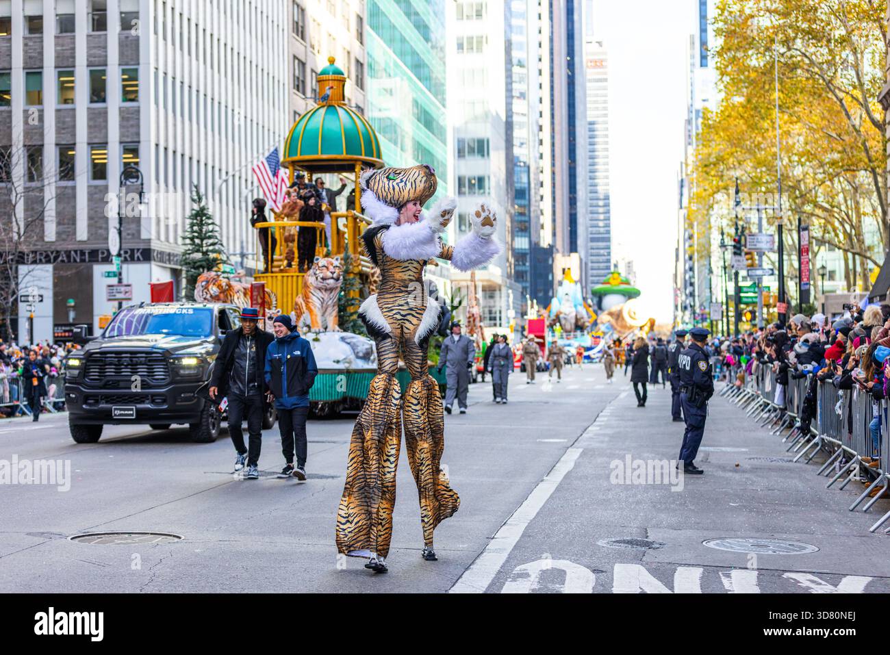 A performer in the 99th Annual Macy's Thanksgiving Day Parade wave to ...