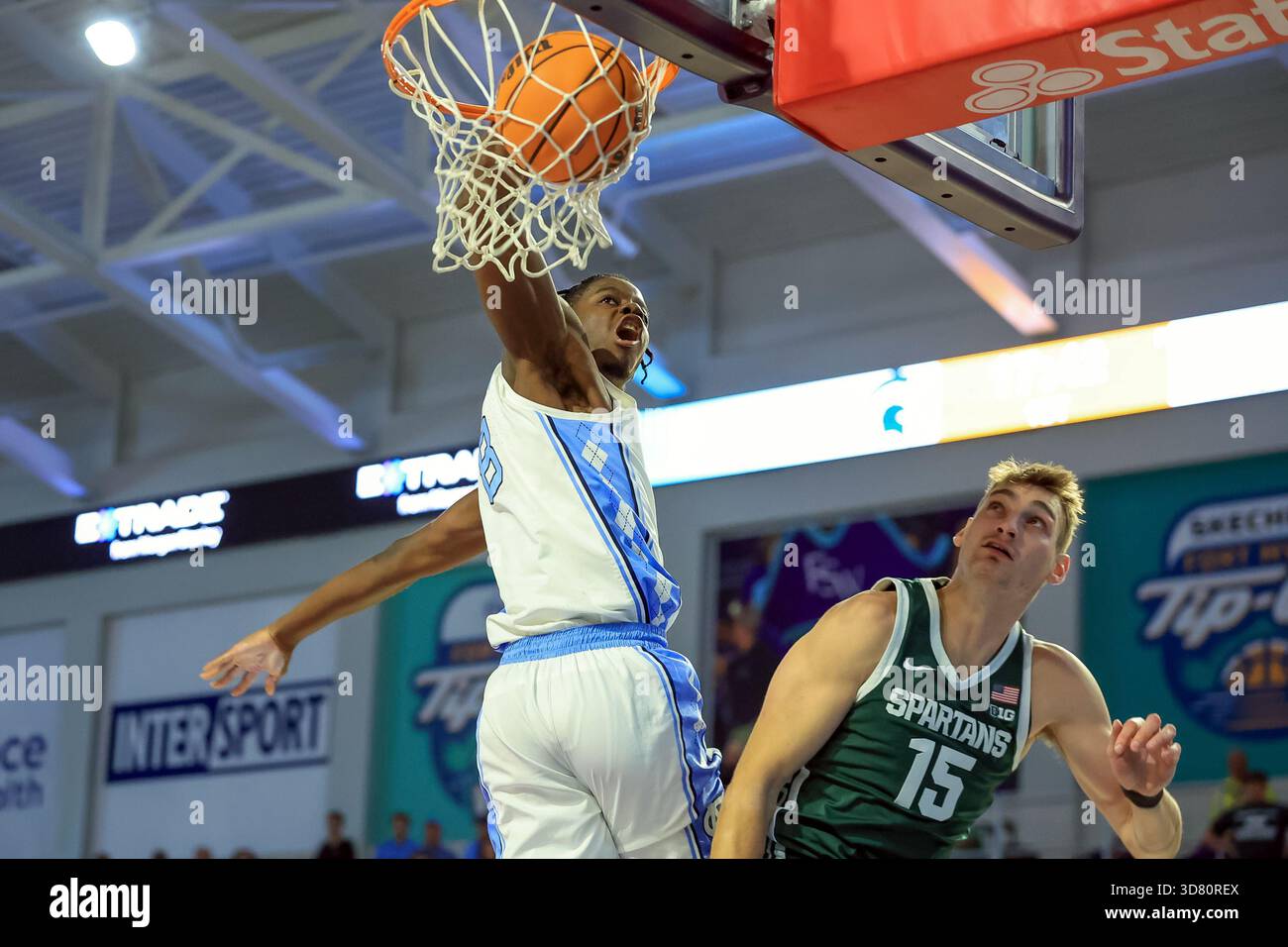 North Carolina forward Caleb Wilson, left, dunks over Michigan State ...