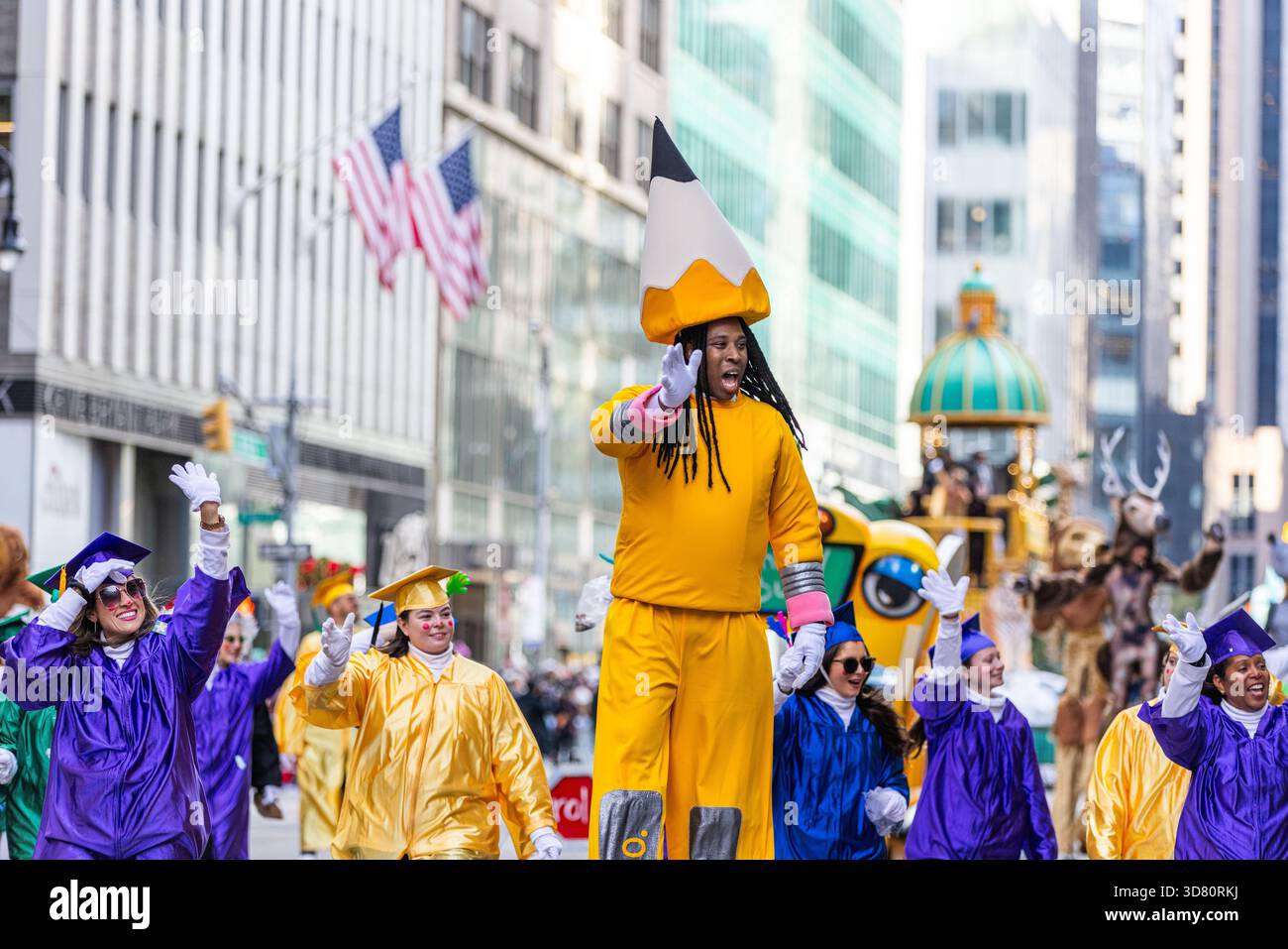 Participants in the 99th Annual Macy's Thanksgiving Day Parade wave to ...