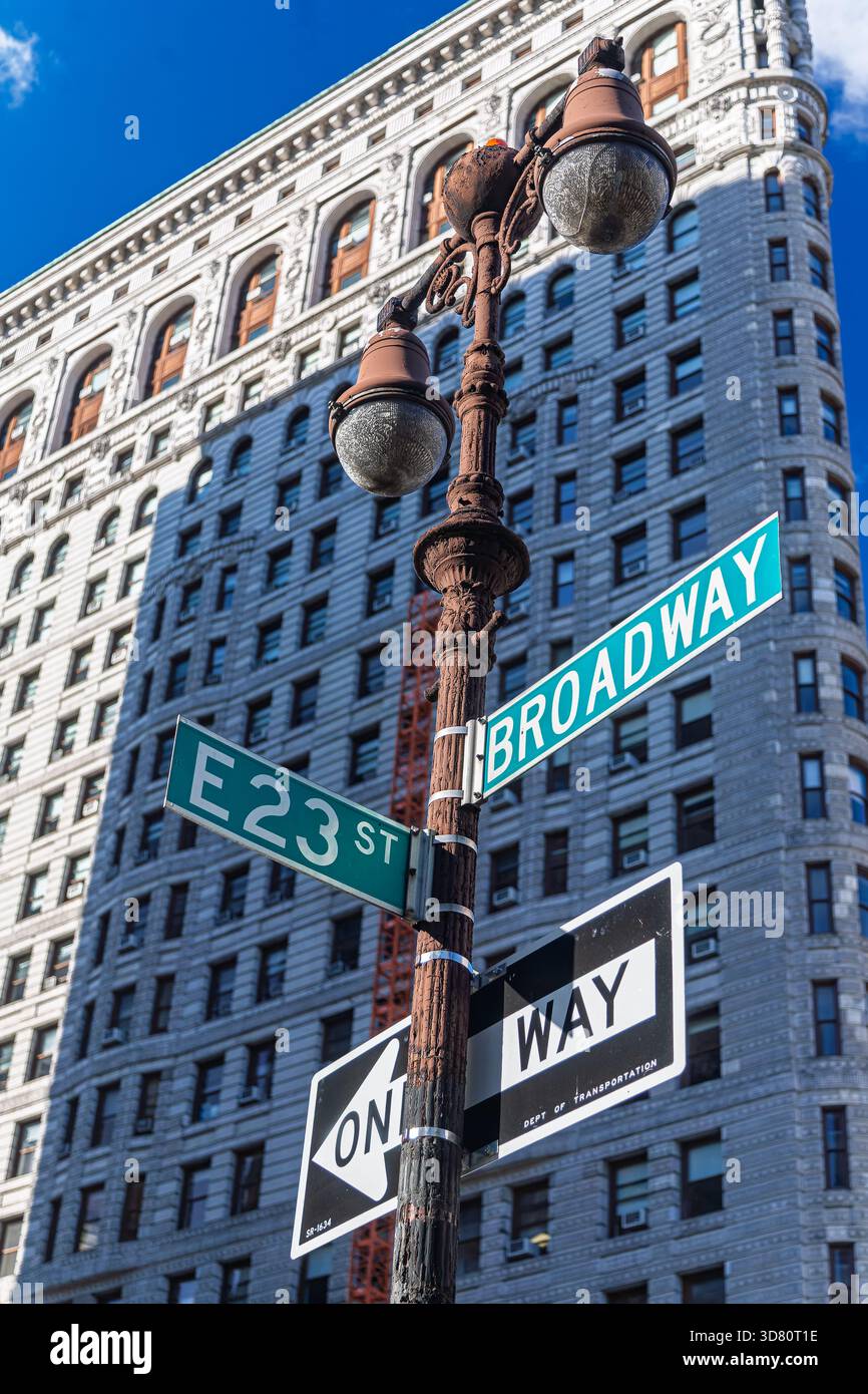 Street signs for Broadway and E 23rd Street are mounted on a vintage ...