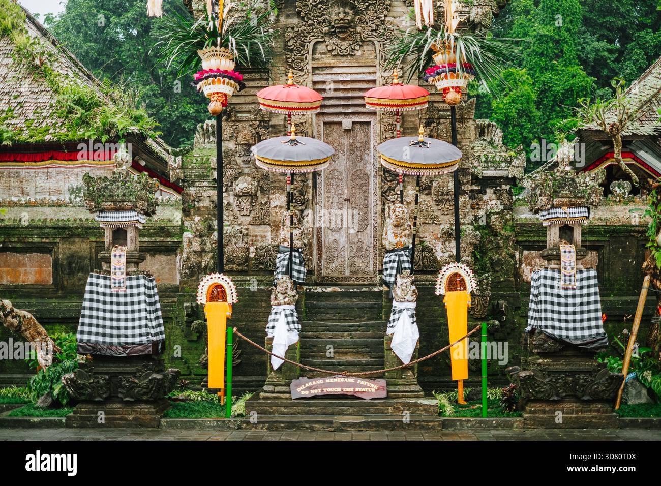 Front view of a stone Balinese temple gate with intricate carvings ...
