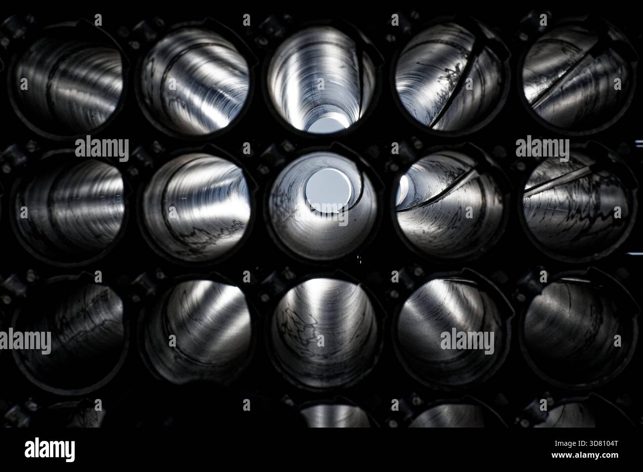 Abstract close-up view inside the barrels of a military multiple rocket ...