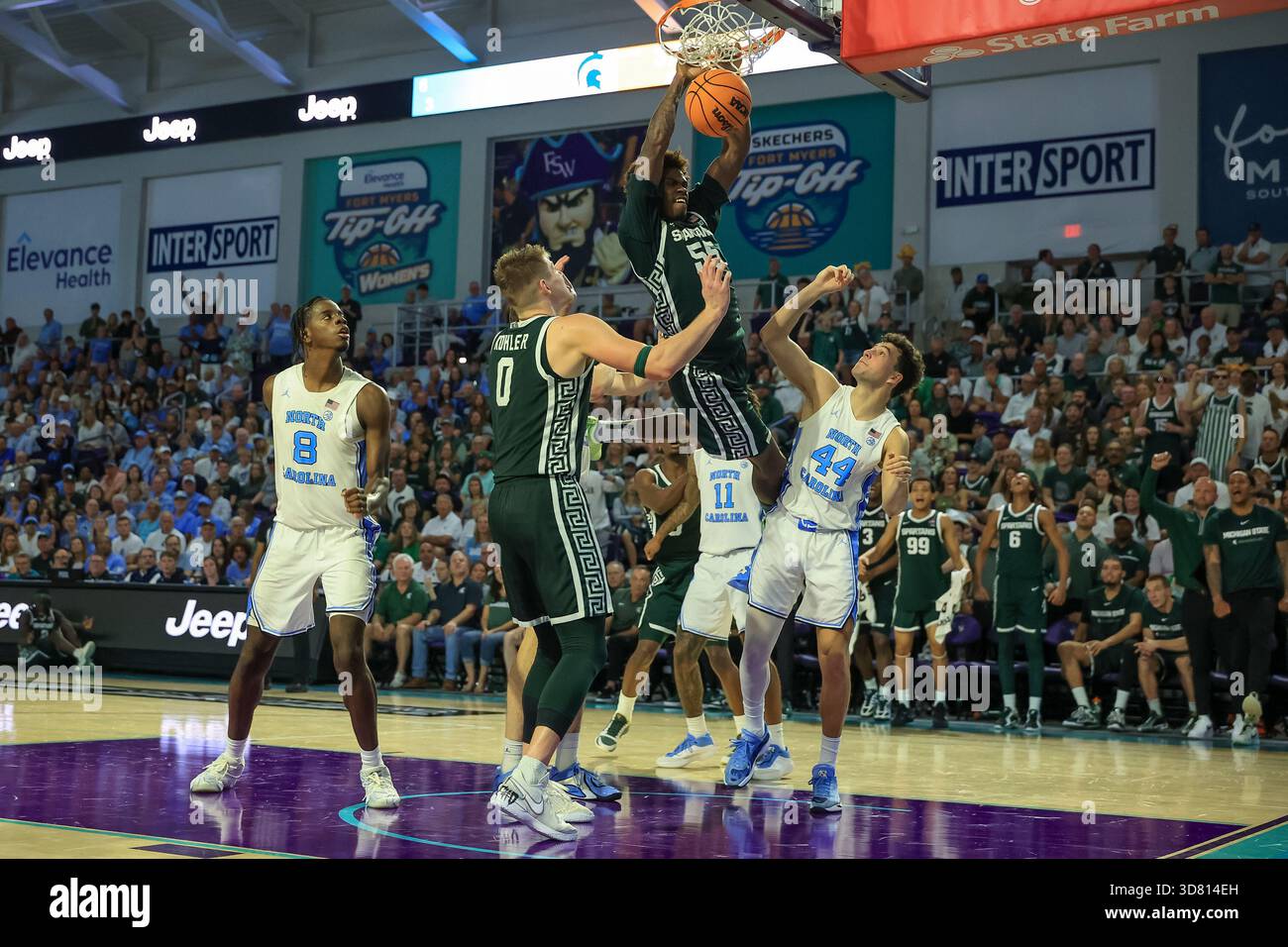 Michigan State forward Coen Carr (55) dunks over North Carolina guard ...
