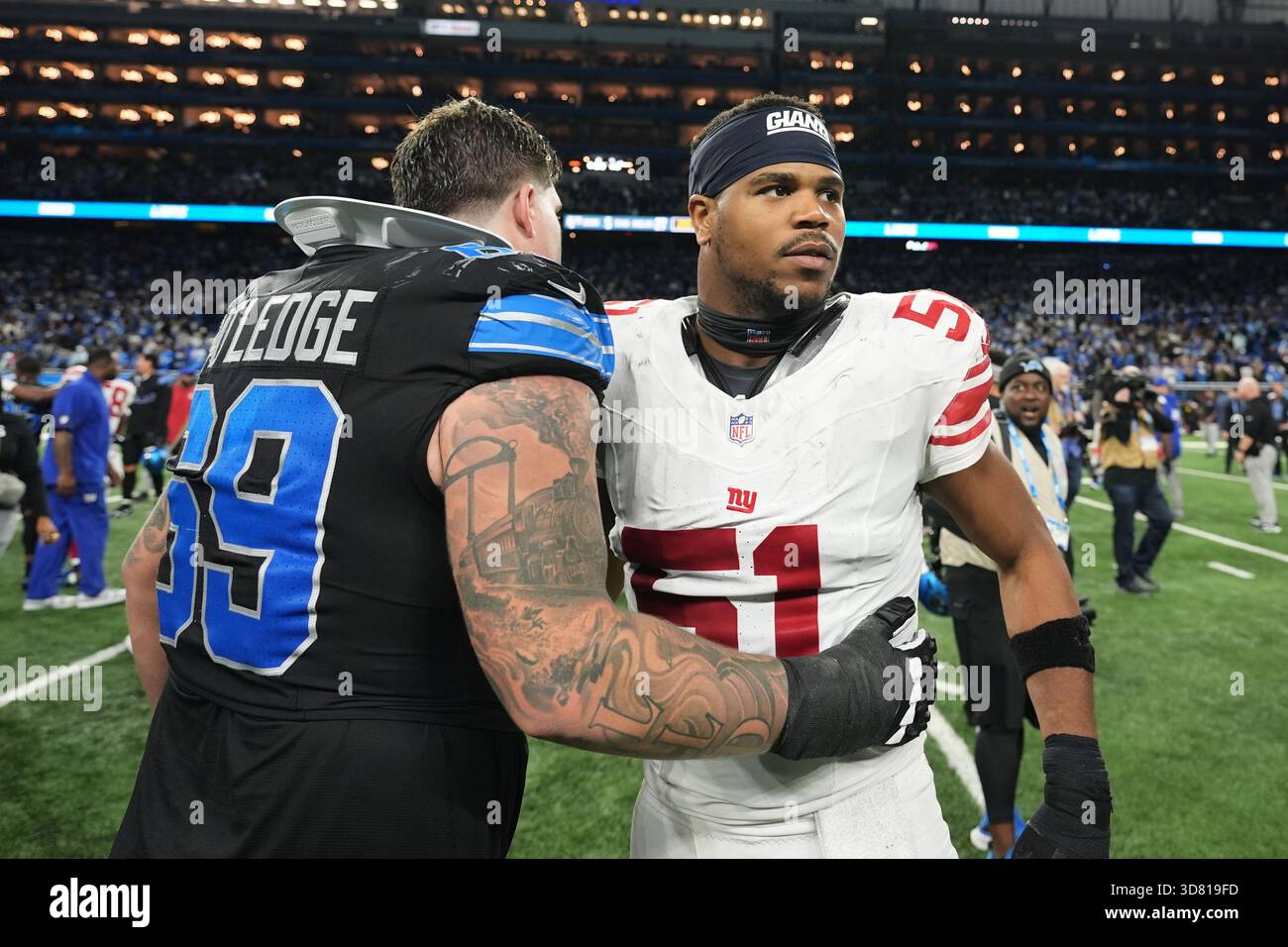 Detroit Lions guard Tate Ratledge, left, greets New York Giants ...