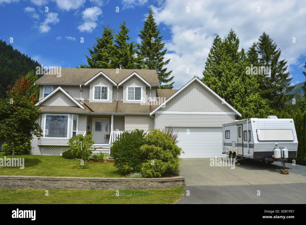 Big residential house with RV trailer parked on driveway. Family house ...