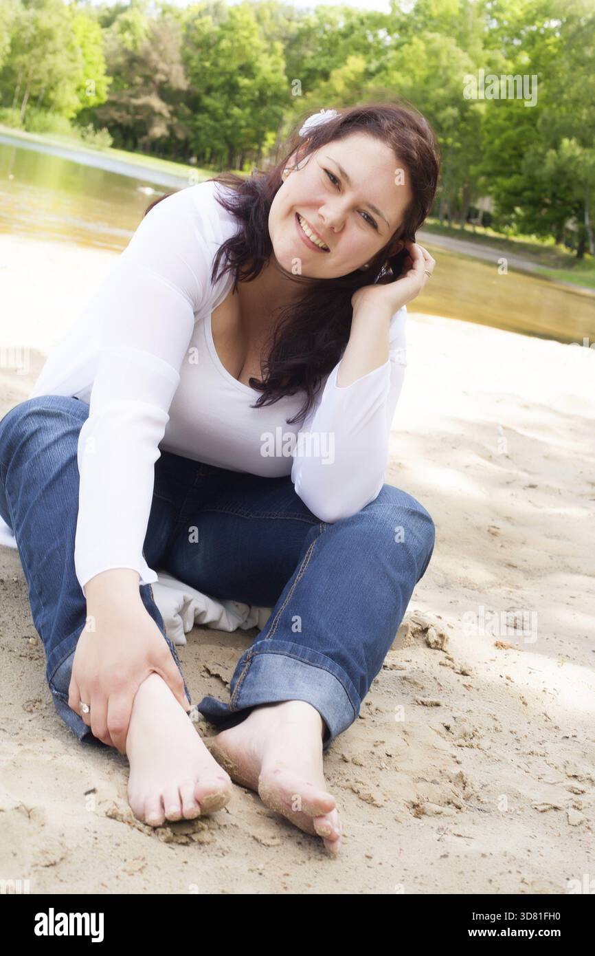 Happy young couple is having fun on a windy park beach Stock Photo - Alamy