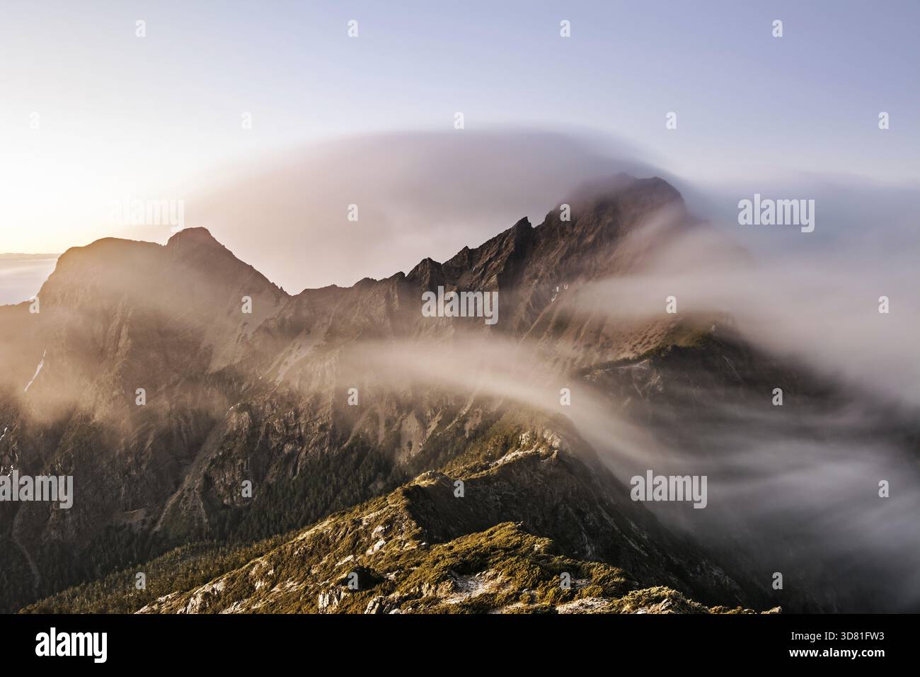 Mountain scenery with clouds and mist in the morning, the peak is ...