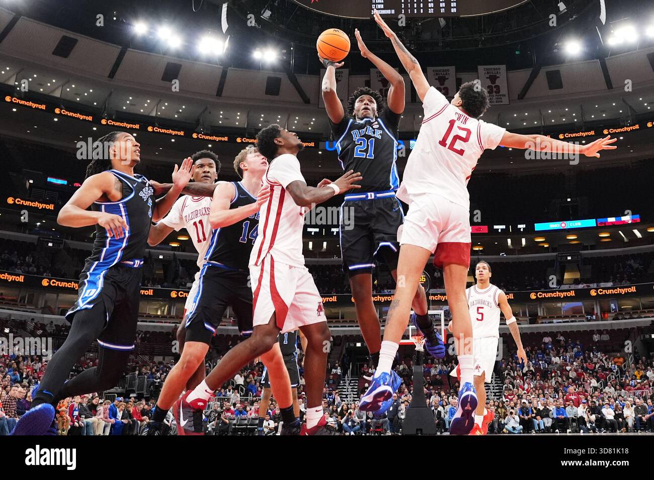 Duke center Patrick Ngongba (21) shoots against Arkansas forward ...