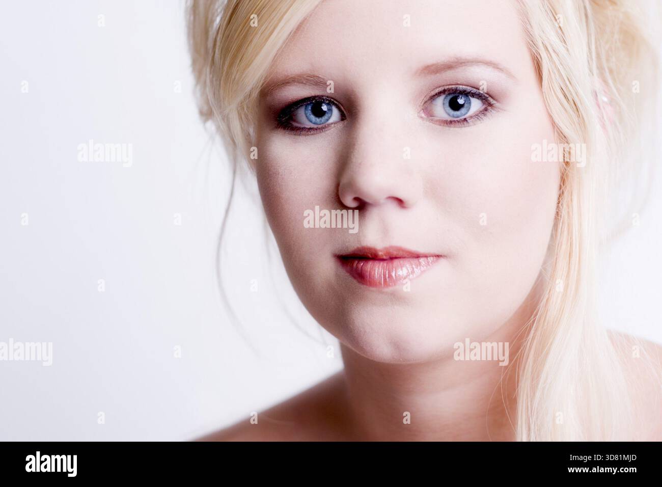 Studio portrait of a blond young lady with bright blue eyes Stock Photo ...