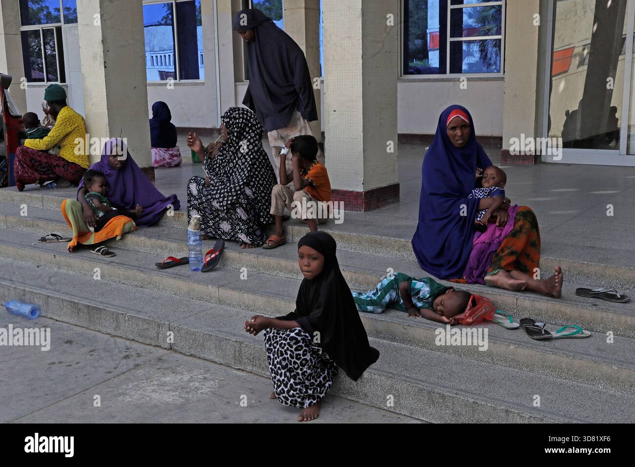 Patients sit at the entrance of Banadir Hospital in Mogadishu, Somalia ...