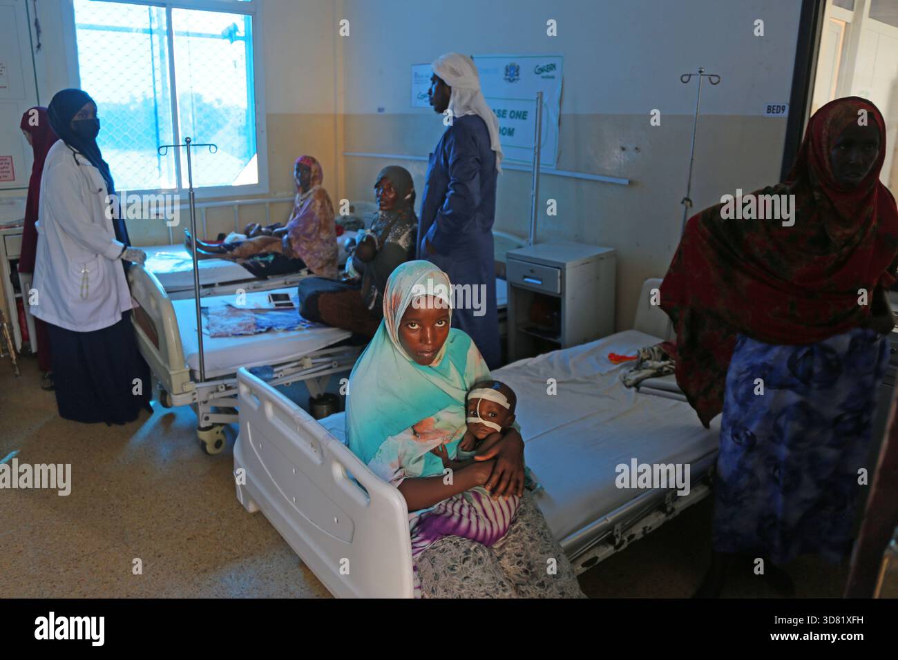 Mothers sit with their malnourished babies at Banadir Hospital in ...