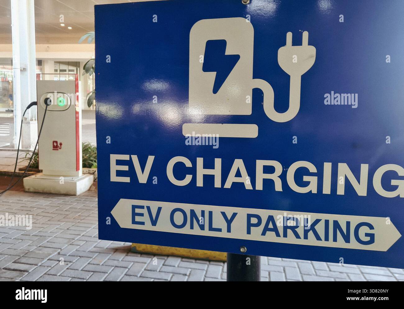 EV charging and EV only parking sign with an electric vehicle charger ...