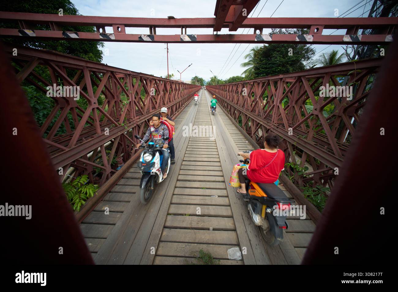 Motorcyclists cross the Old French Bridge, a French colonial-era steel ...
