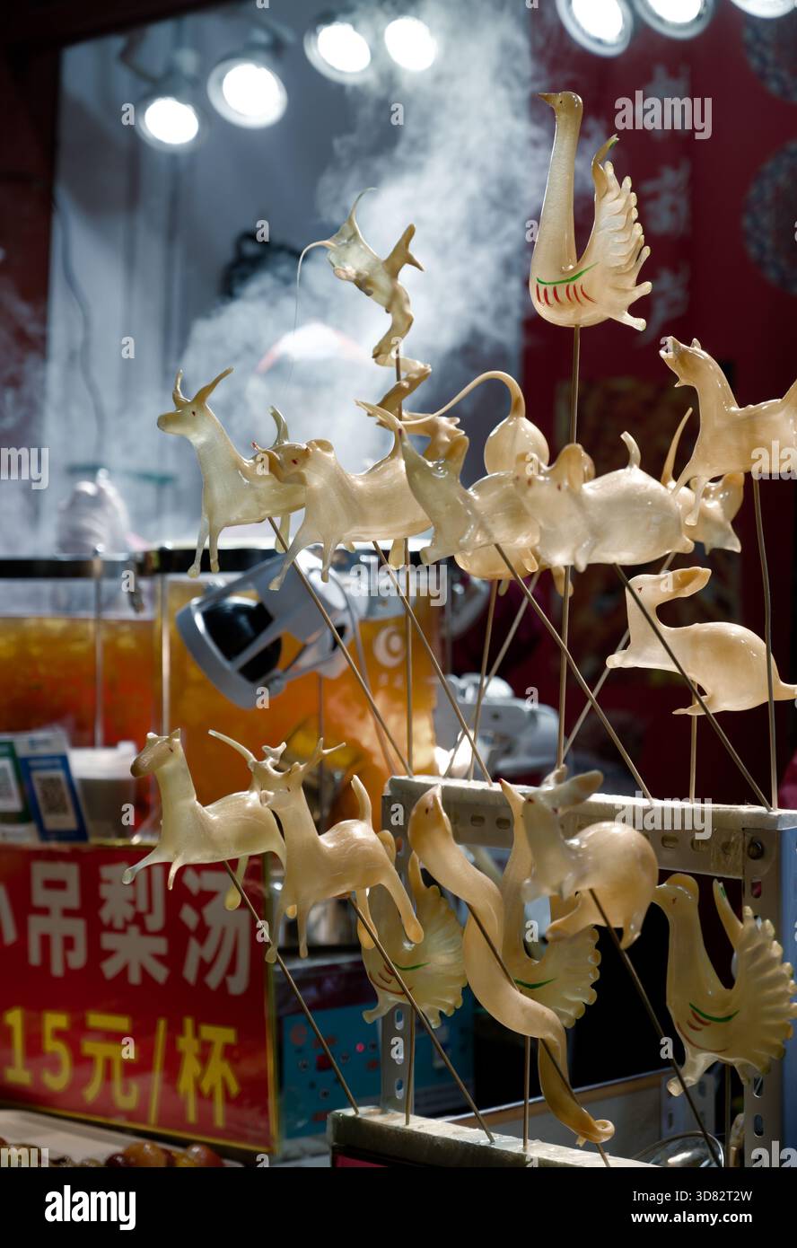 Sugar animal figurines on sticks glowing under steam and spotlights at ...