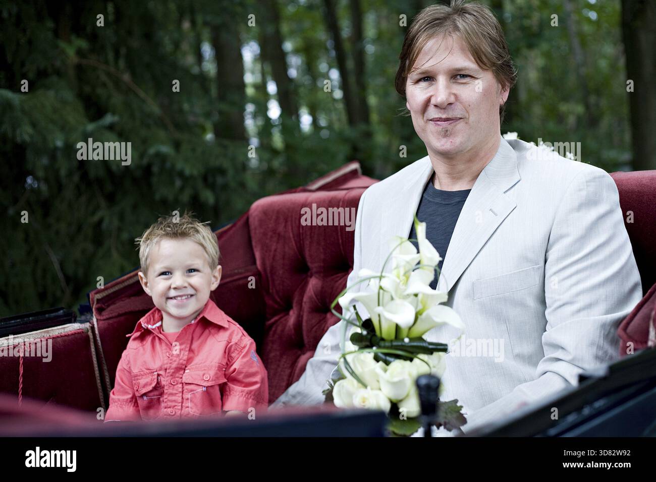 Father and son posing in bridal coach on route to the bride Stock Photo ...