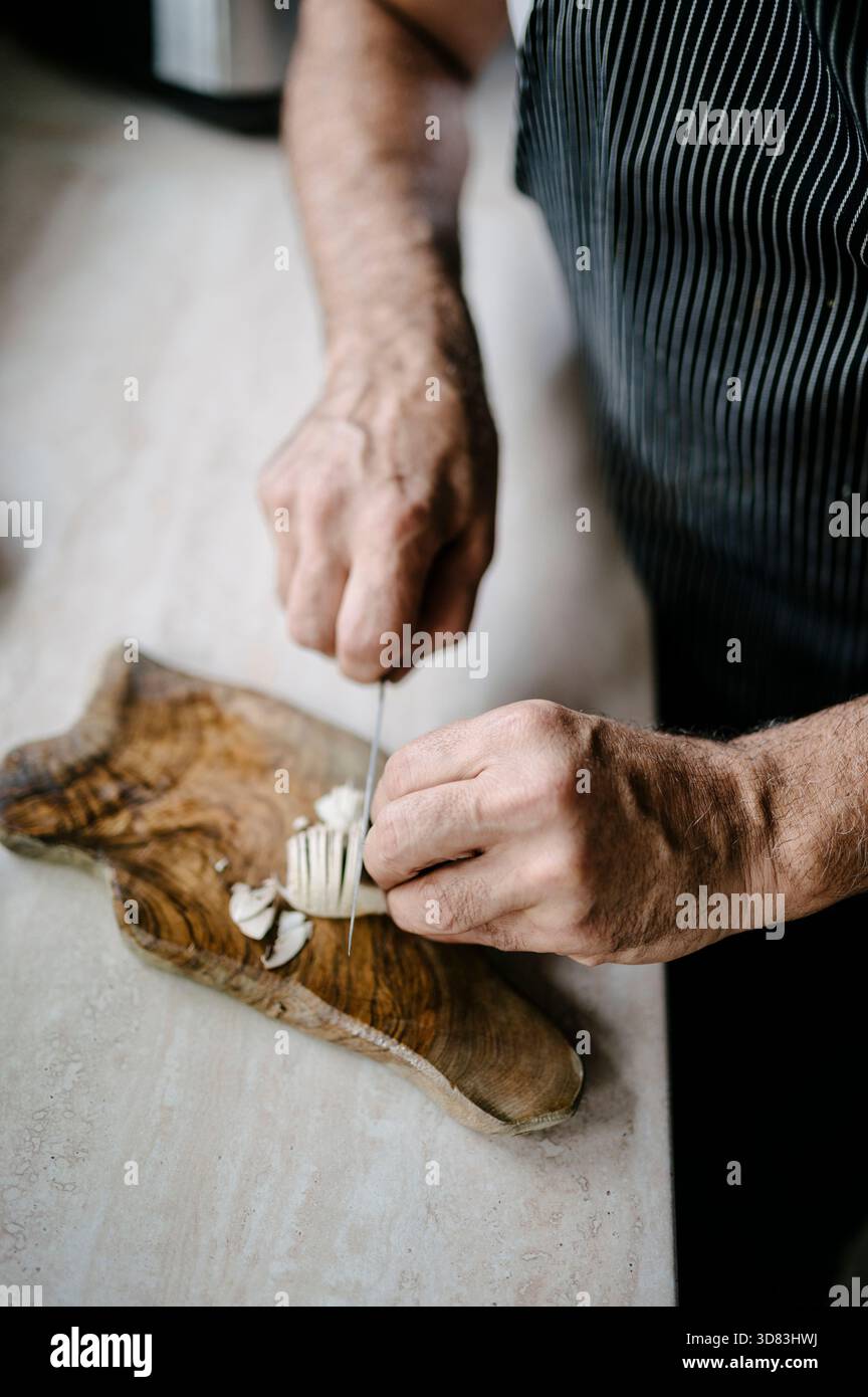 Hands skillfully chopping garlic hi-res stock photography and images ...