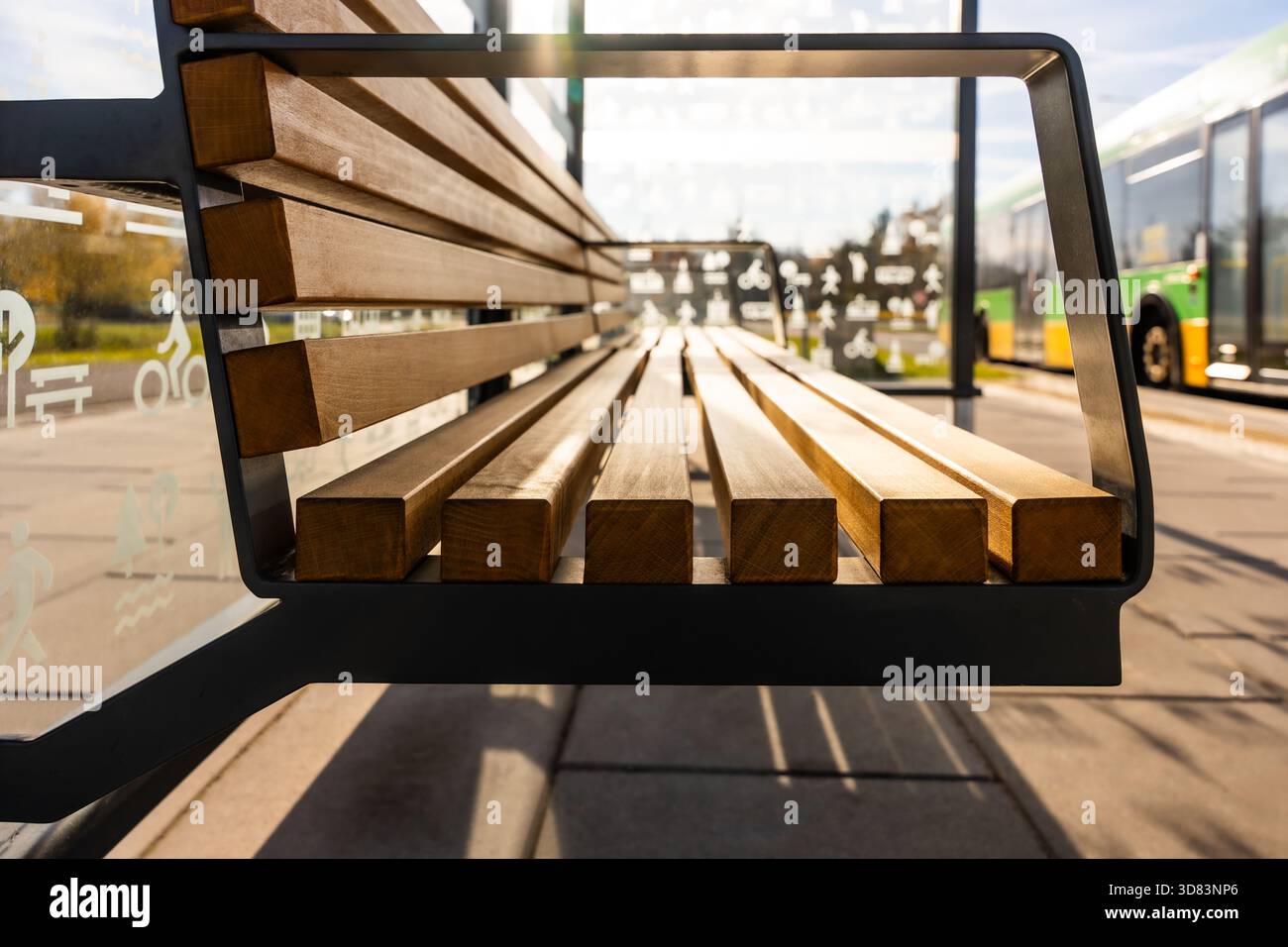 Modern Wooden Bench At City Bus Stop With Glass Shelter And Bus In ...