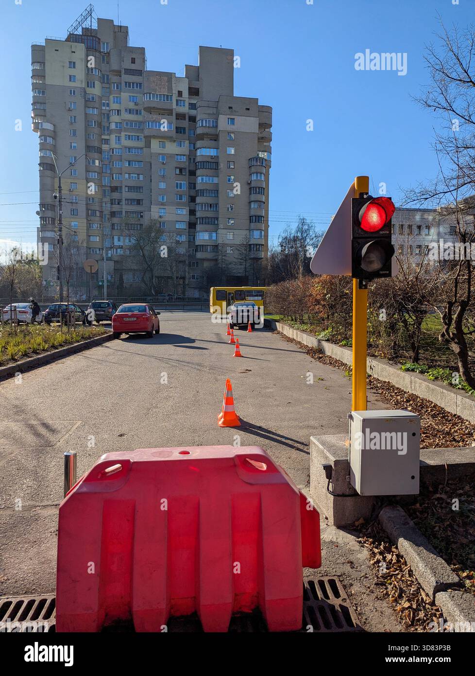 A traffic light and barrier stand at the exit from the park area into ...