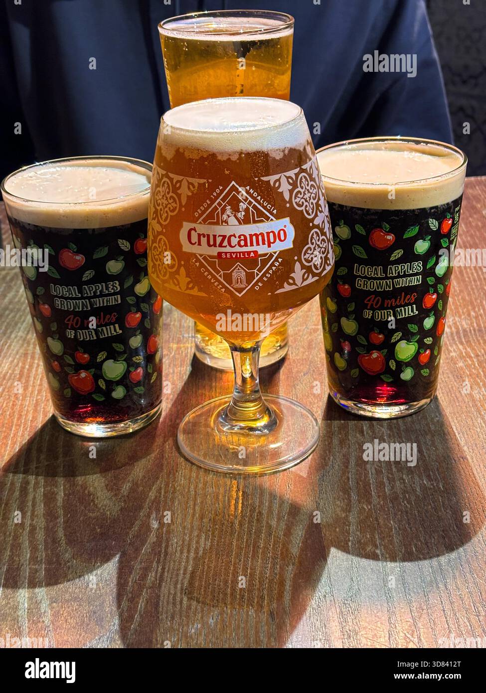 Assortment of Cider and Beer Glasses Featuring Cruzcampo Branding and ...