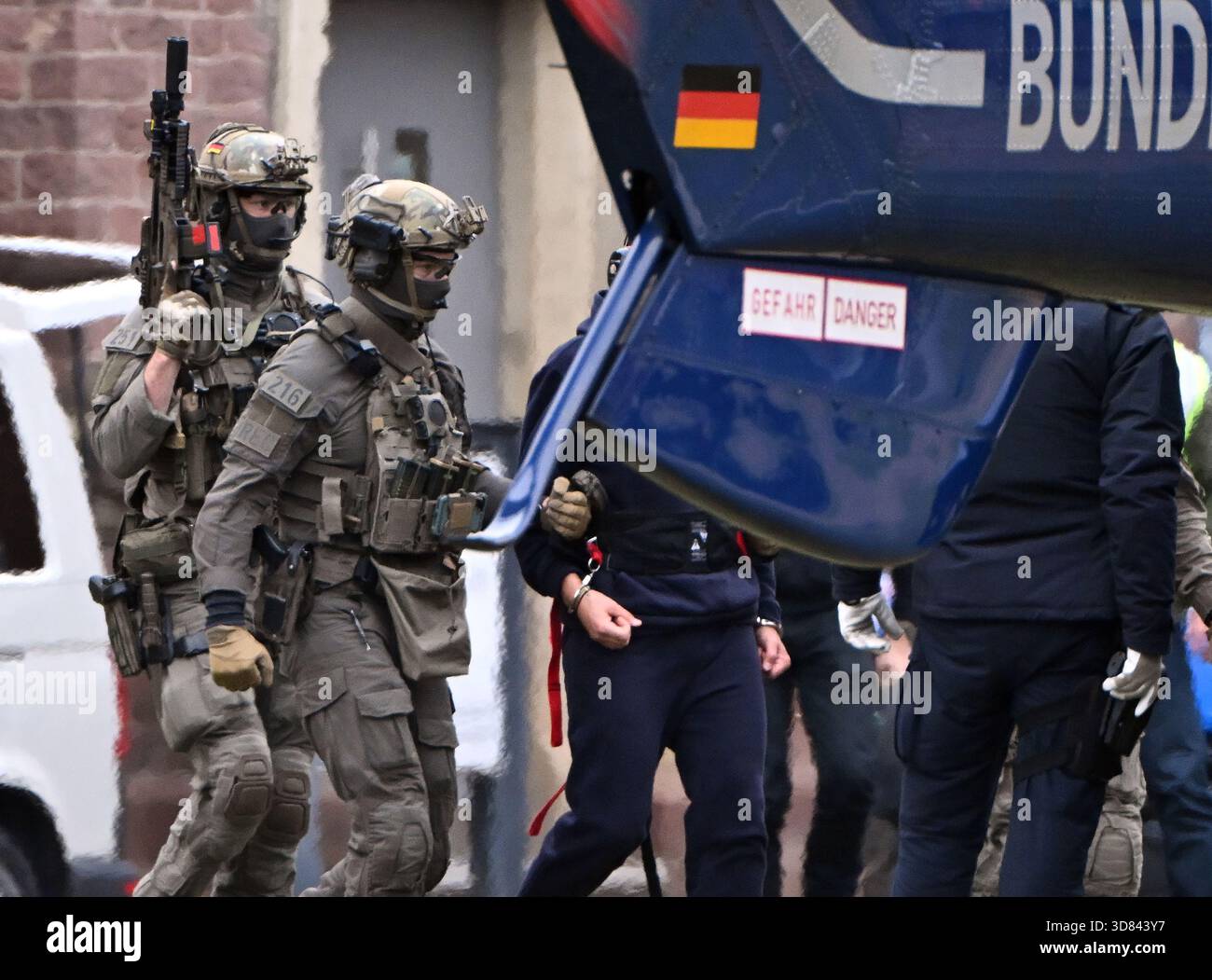 A person is led to a helicopter in a government center in Karlsruhe ...