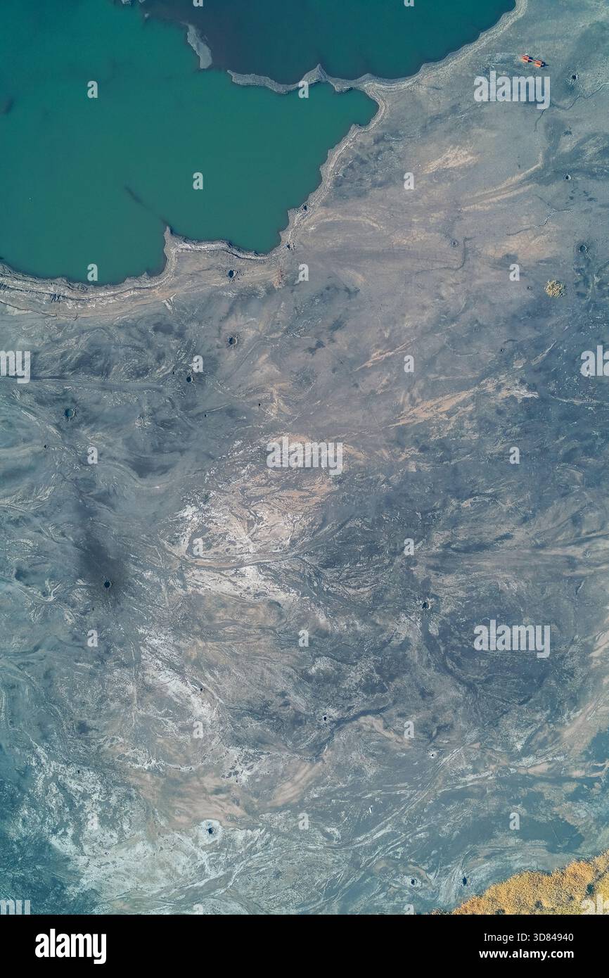 Vertical aerial view of a sharp pollution boundary. Emerald green ...