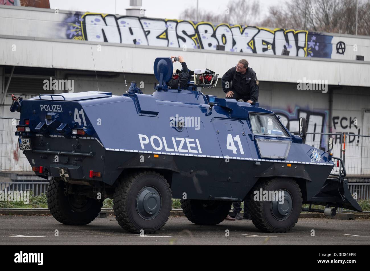 28 November 2025, Hesse, Gießen: A police officer poses for a selfie on ...
