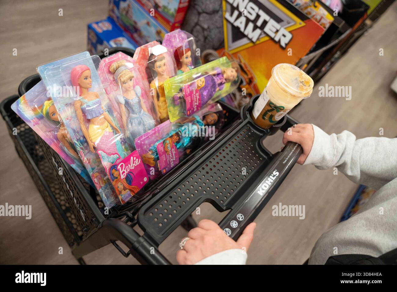 A shopping cart full of Barbies can be seen as shoppers browse through ...