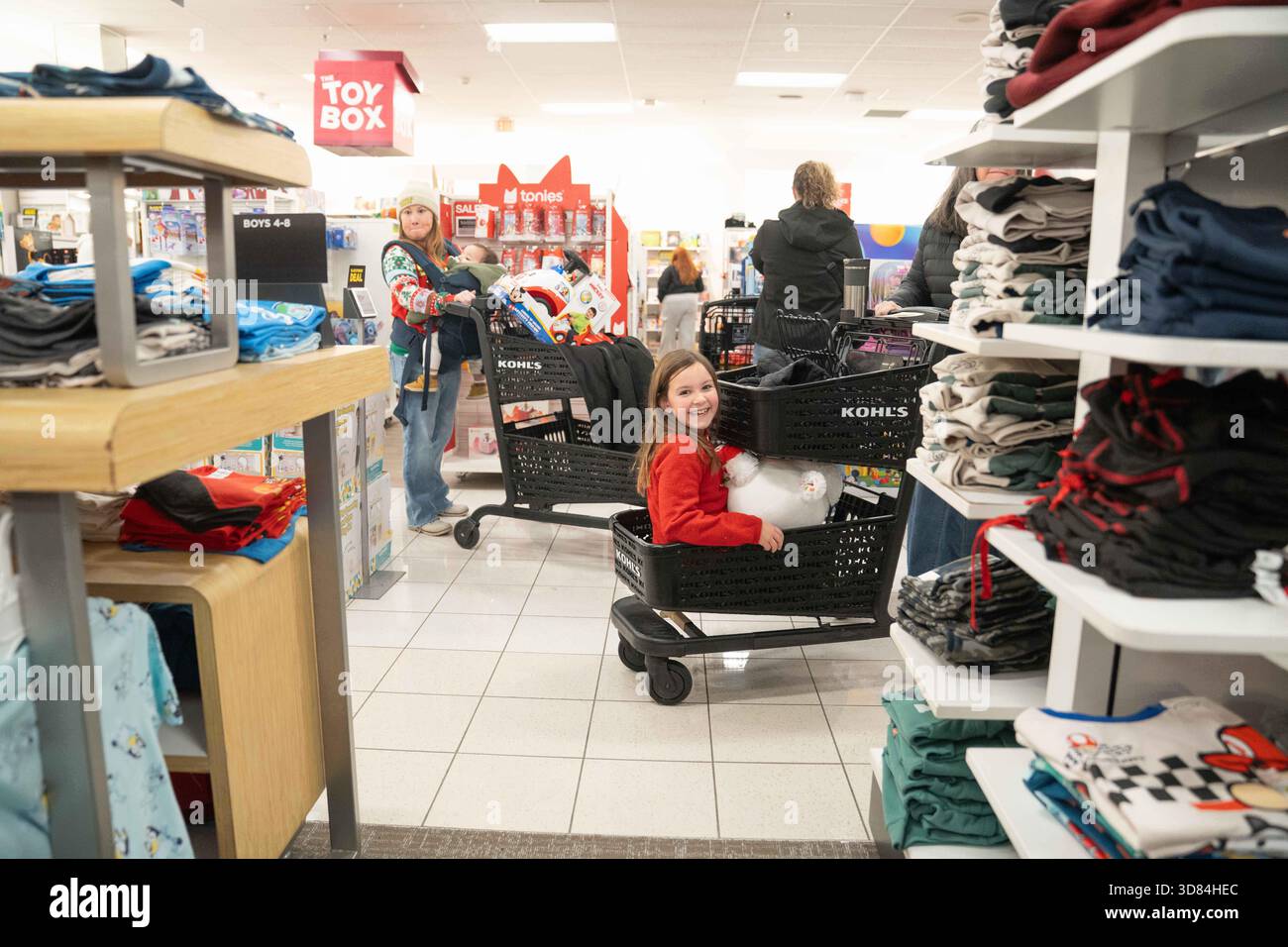 Eva Klein sits in the bottom of her grandmothers shopping cart as ...