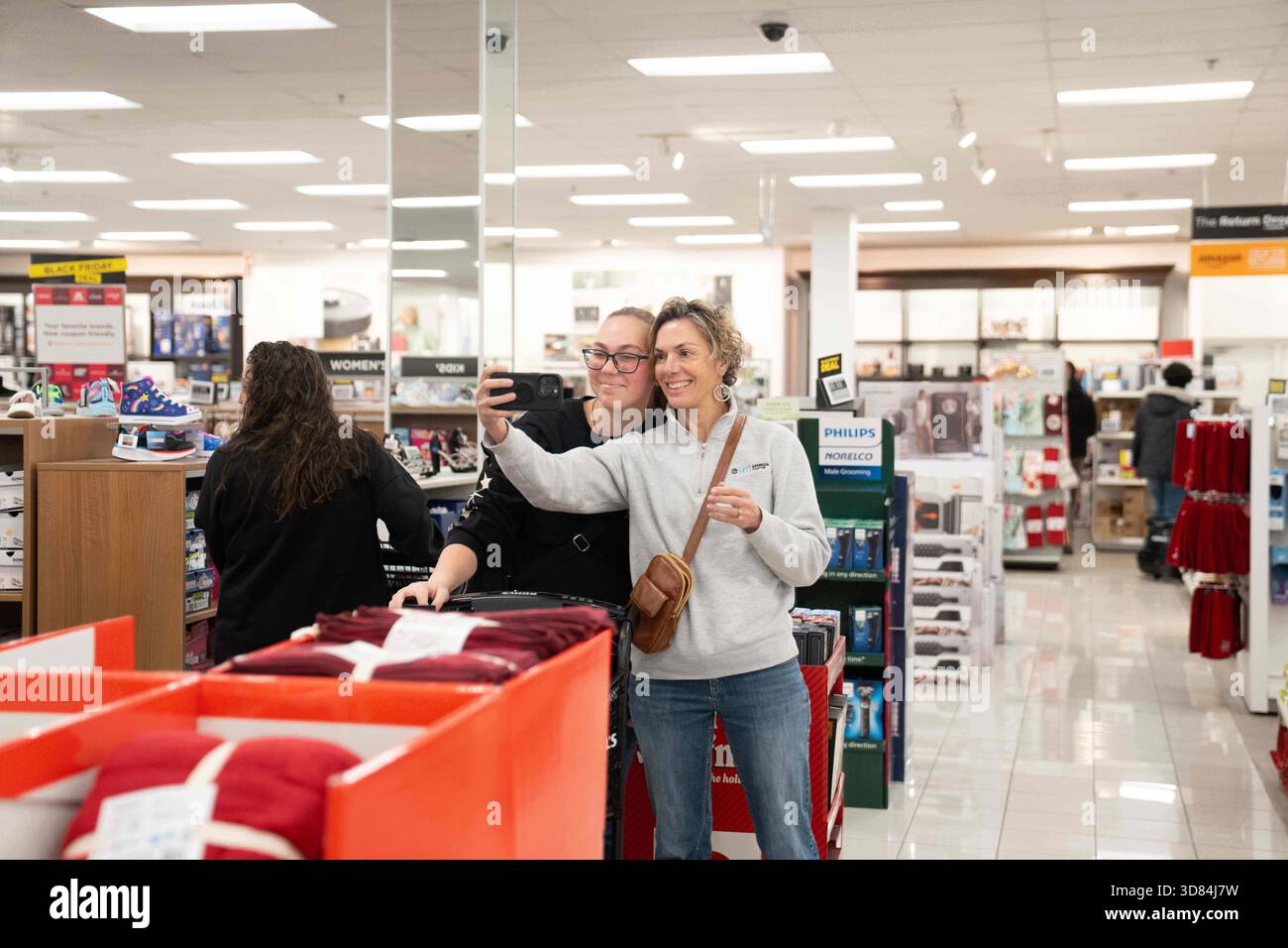 Meredith Dollevovt and daughter Annika Pose for a selfie as shoppers ...