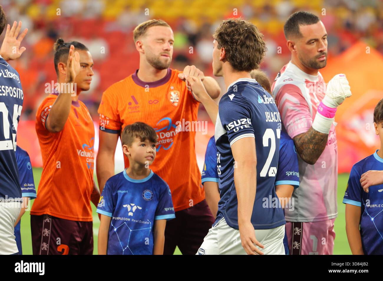 Keegan Daniel Jelacic (23 Melbourne) fist pumps with Brisbane players as he returns to his old ...