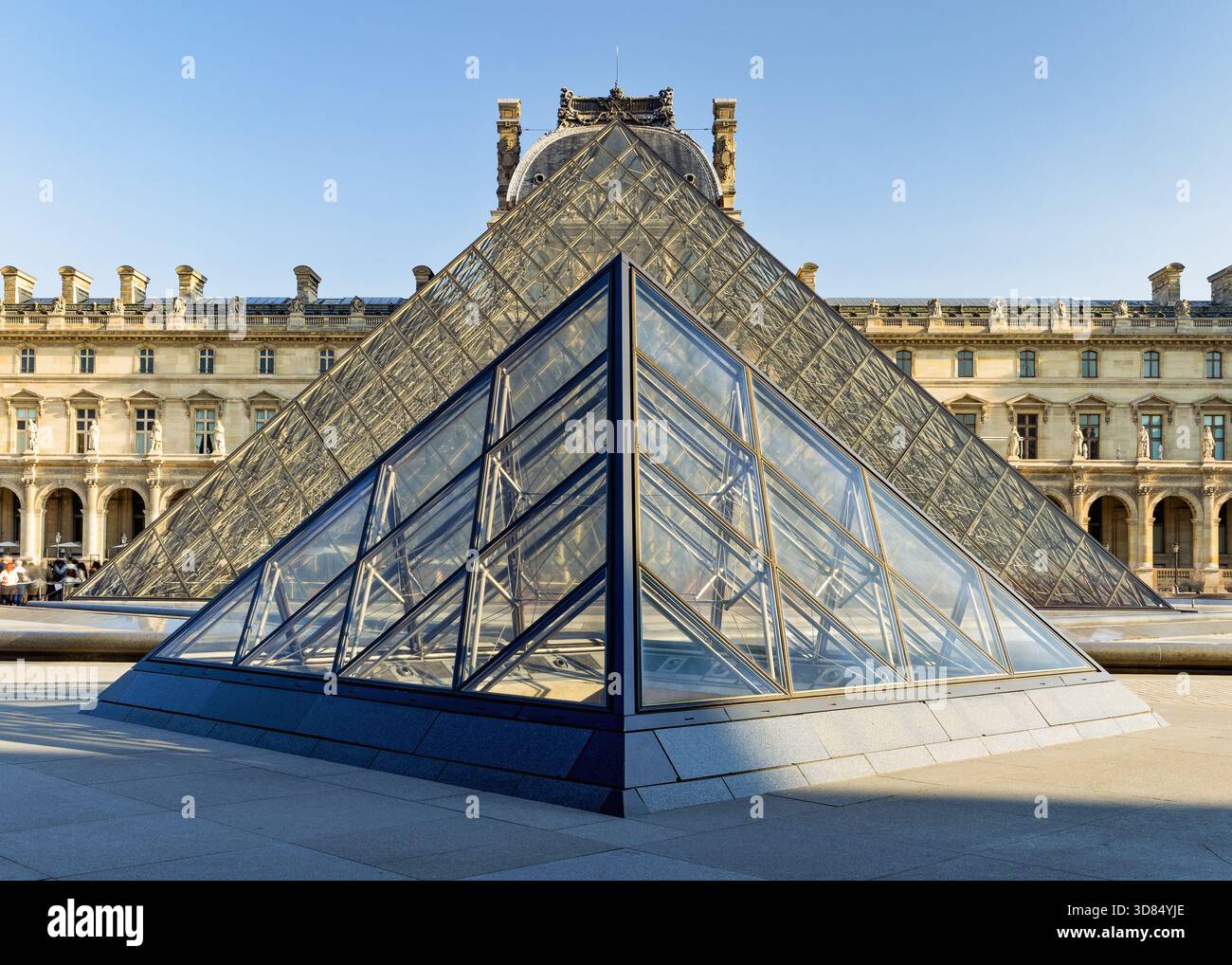 The glass pyramid stands prominently in front of the historic Louvre ...