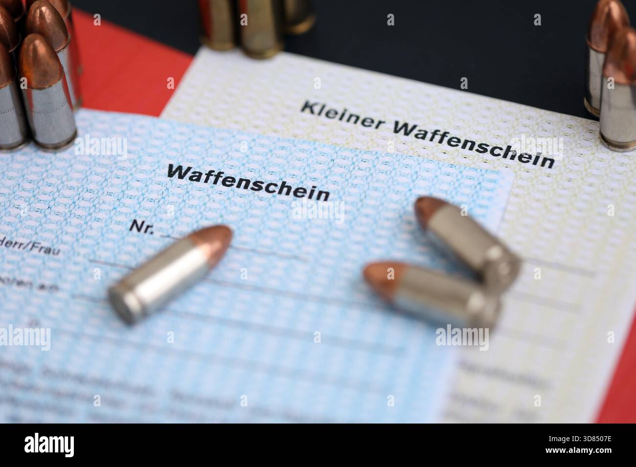 German firearms licenses and bullets on Germany flag close up. Gun ...