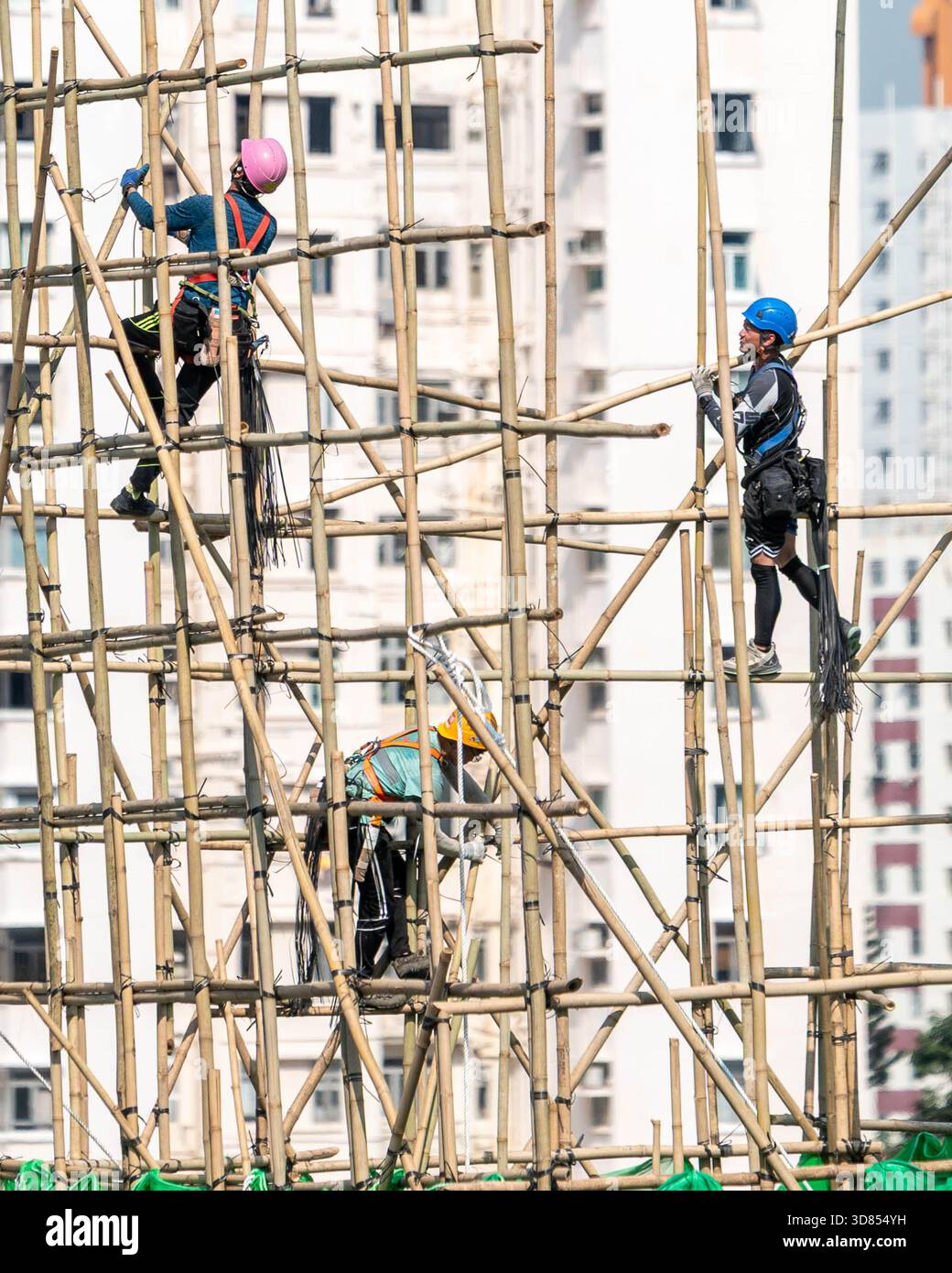 March 24, 2025, Hong Kong, China: Bamboo scaffolding workers, known as ...