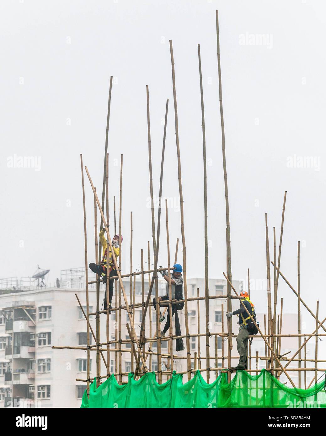 March 28, 2025, Hong Kong, China: Bamboo scaffolding workers, known as ...