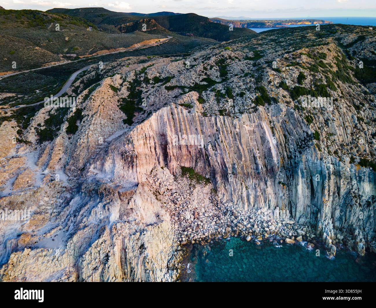 Aerial view of rugged cliffs meeting the turquoise sea, a mesmerizing ...