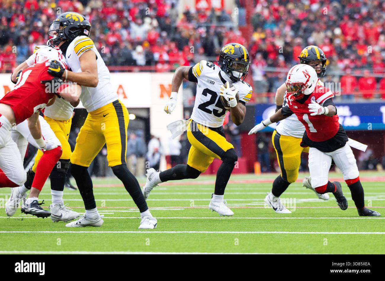 Iowa running back Nathan McNeil (25) rushes against Nebraska defensive ...