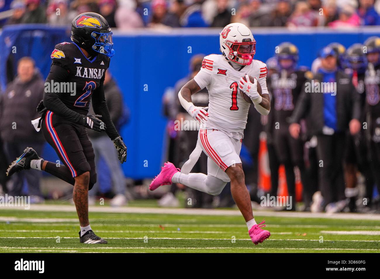 Utah running back Wayshawn Parker (1) is chased by Kansas safety Lyrik ...