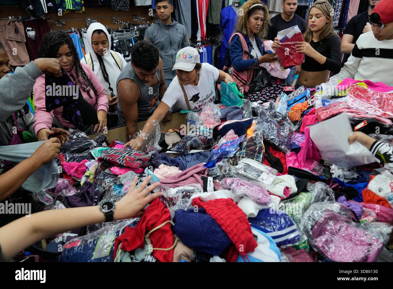 People shop for clothes marked down to one dollar per item on Black ...