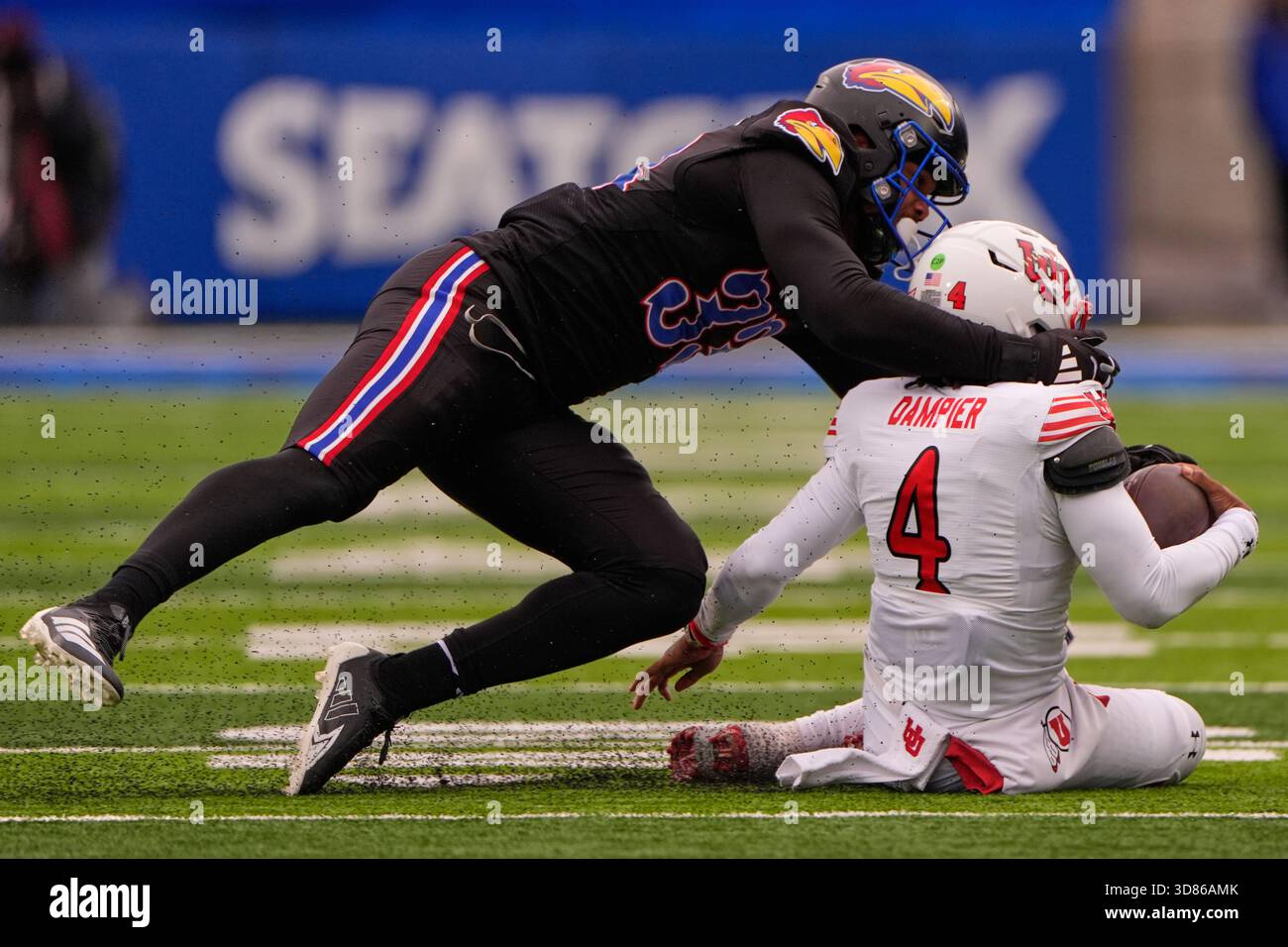 Kansas defensive end Leroy Harris III (33) tackles Utah quarterback ...