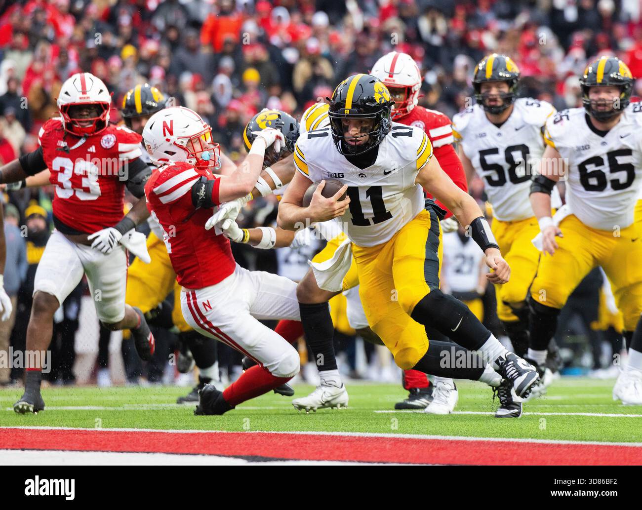 Iowa quarterback Mark Gronowski (11) runs in a touchdown against ...