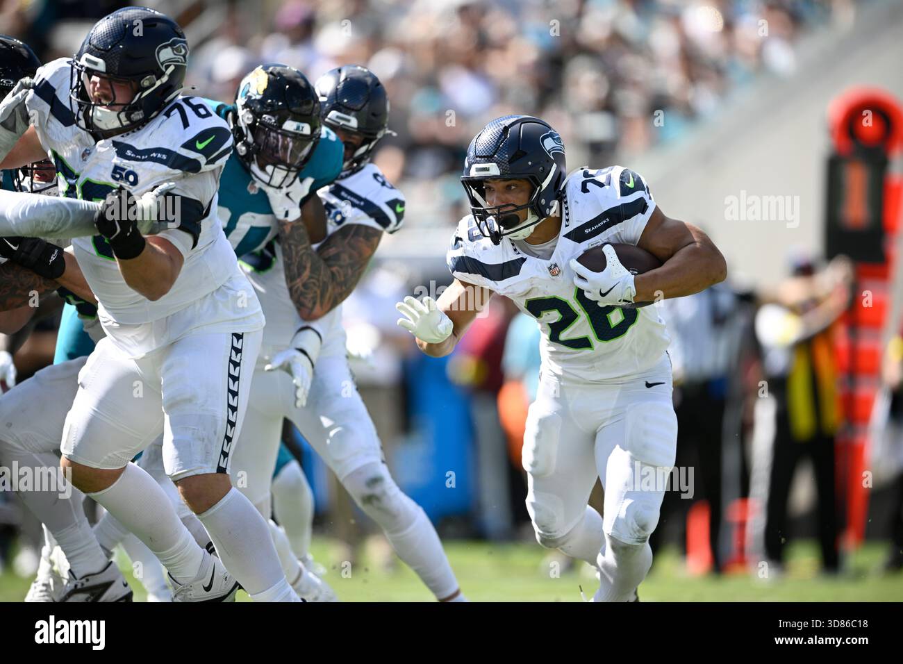 Seattle Seahawks running back Zach Charbonnet (26) rushes for yardage ...