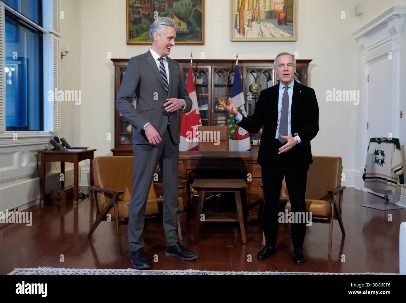 Prime Minister Mark Carney, right, jokes with Northwest Territories ...