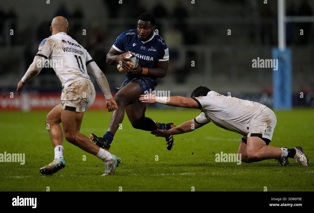 Sale Sharks' Nathan Jibulu is tackled by Exeter Chiefs' Bachuki ...